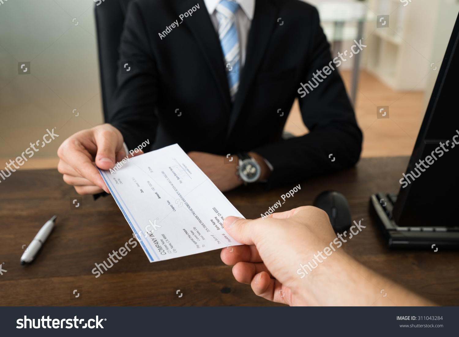 stock-photo-close-up-of-businessman-hands-giving-cheque-to-other-person ...
